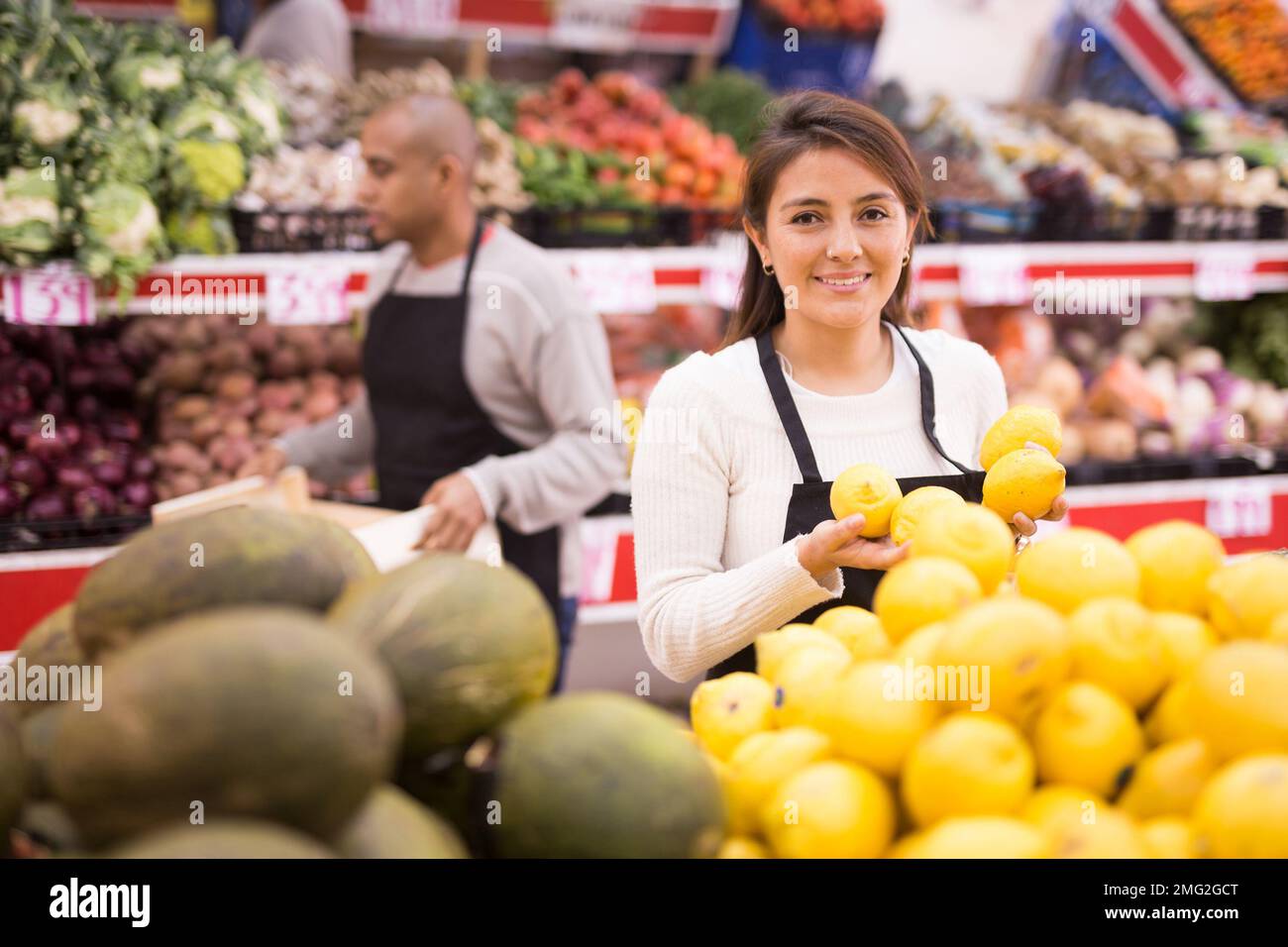 Smiling supermarket workers in fruit and vegetables section Stock Photo ...