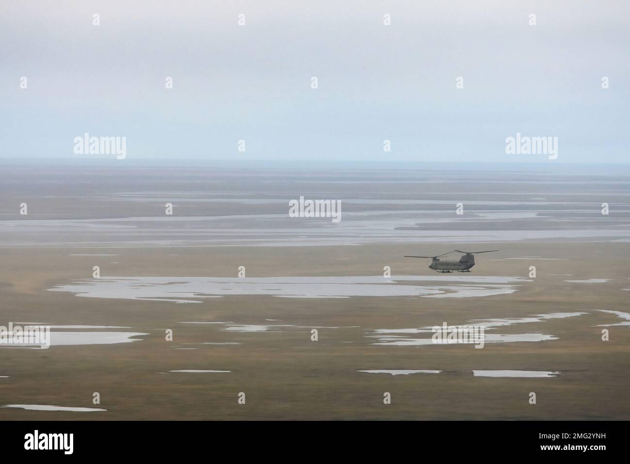 A CH-47 Chinook helicopter flies over the tundra along Alaska’s North ...