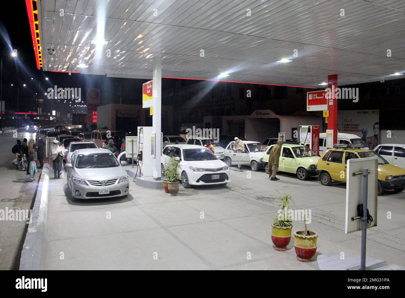 People wait for their turn to get fuel at a petrol station, a day after a country-wide power ...