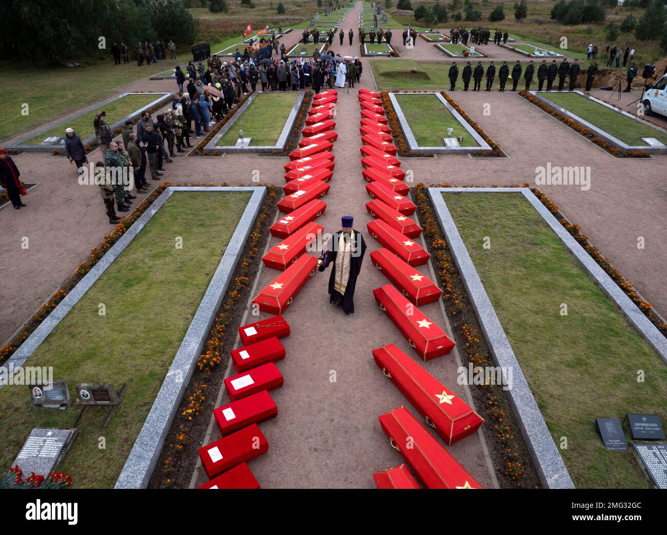 An Orthodox priest conducts a burial ceremony of Soviet soldiers killed ...