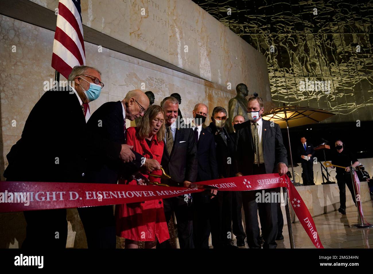 Members of the Eisenhower Memorial Commission cut a ribbon at the ...