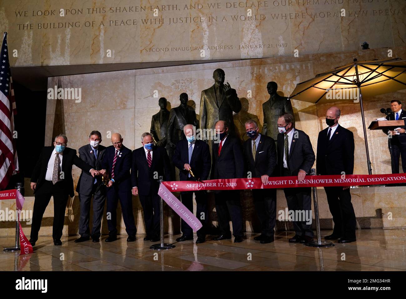 Members of the Eisenhower Memorial Commission cut a ribbon at the ...