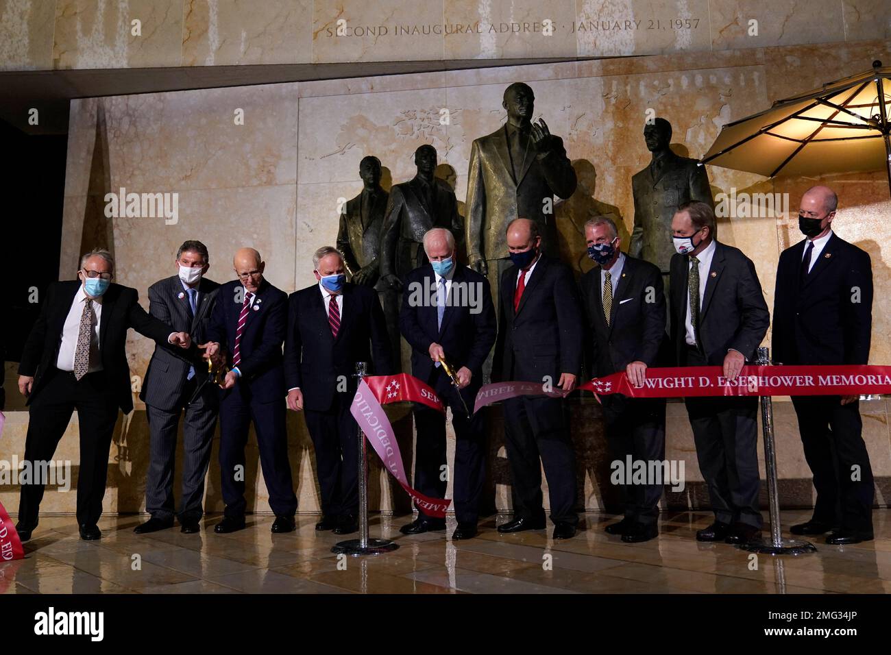Members of the Eisenhower Memorial Commission cut a ribbon at the ...