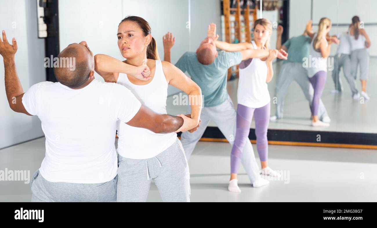 Hispanic girl practicing elbow strike during self defence course Stock Photo - Alamy