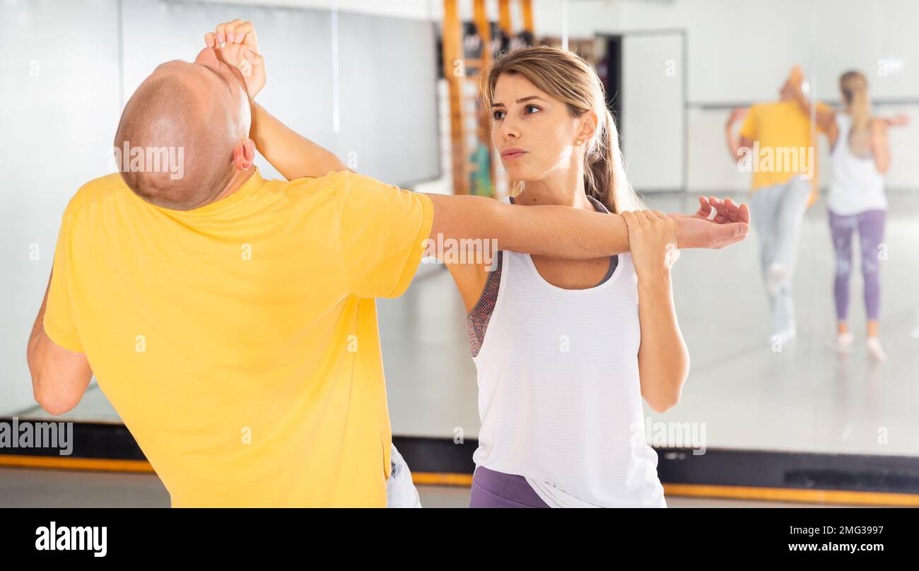 Girl using palm to launch blow in chin during self defence training ...