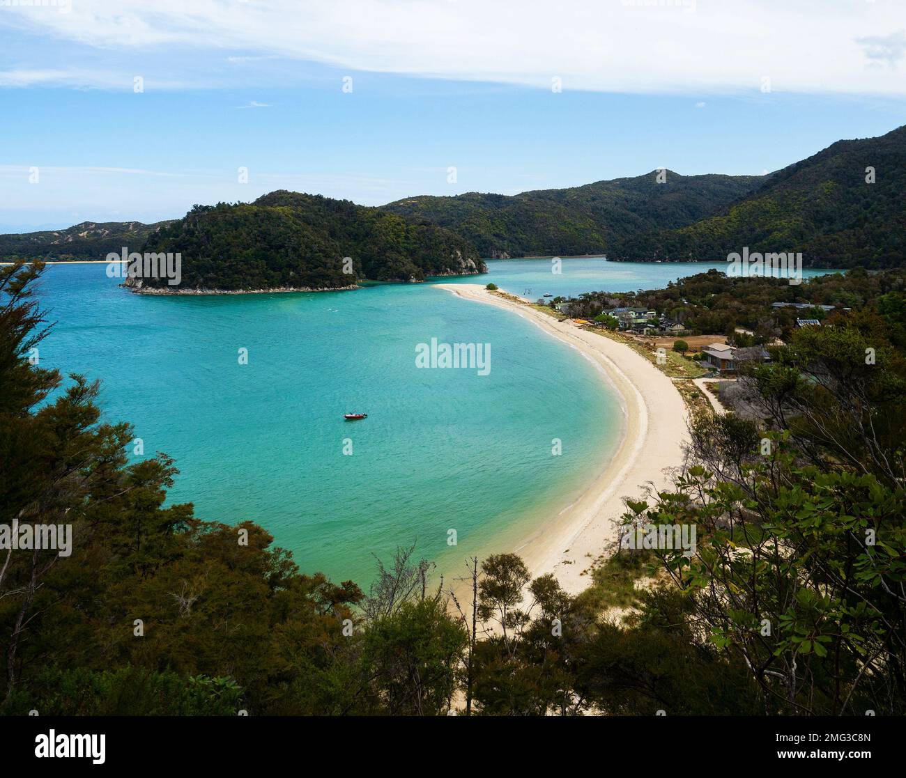 Elevated view of tropical pacific ocean beach surrounded by lush green ...