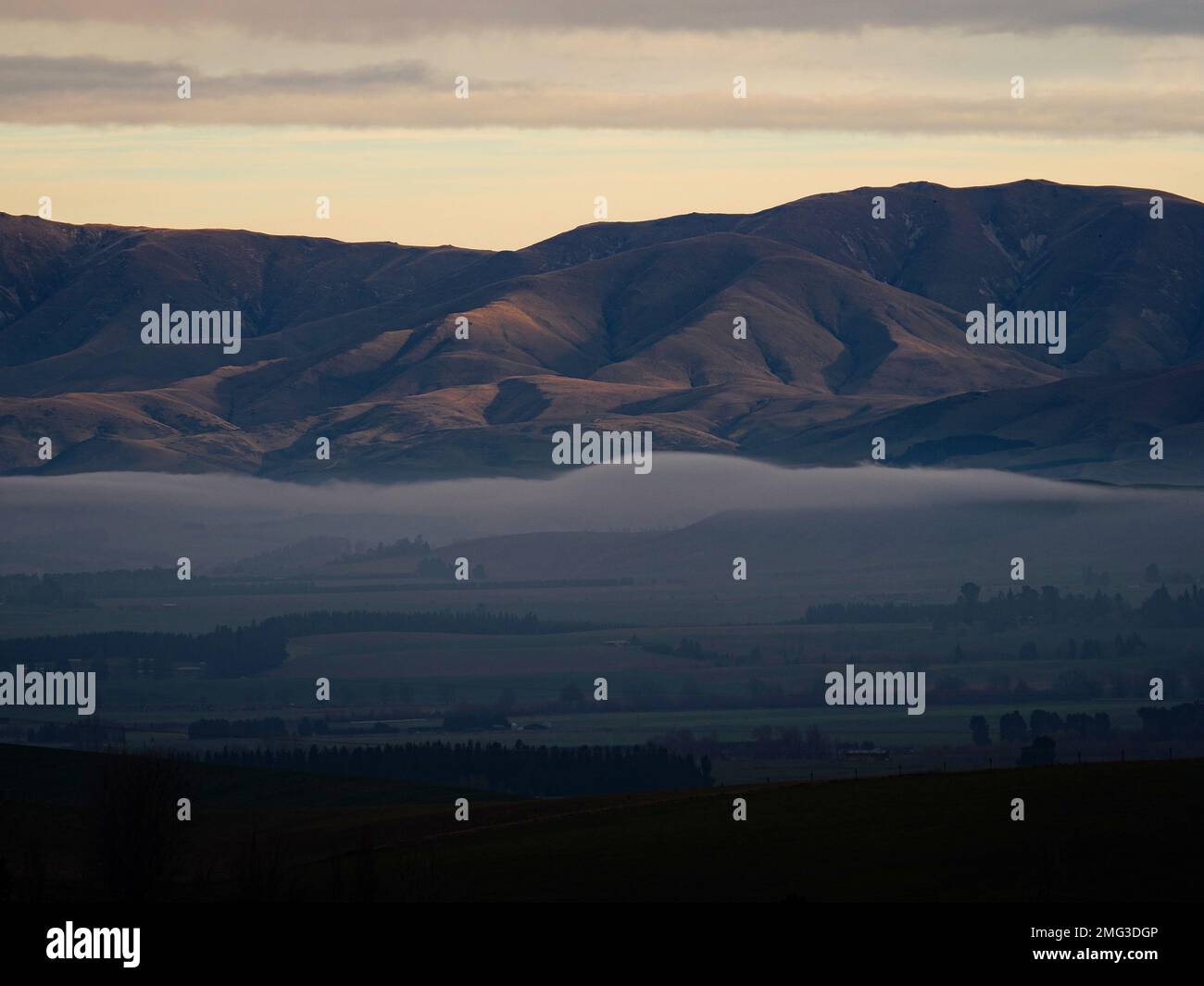 Panorama view of mountain range with low hanging clouds along Highway ...