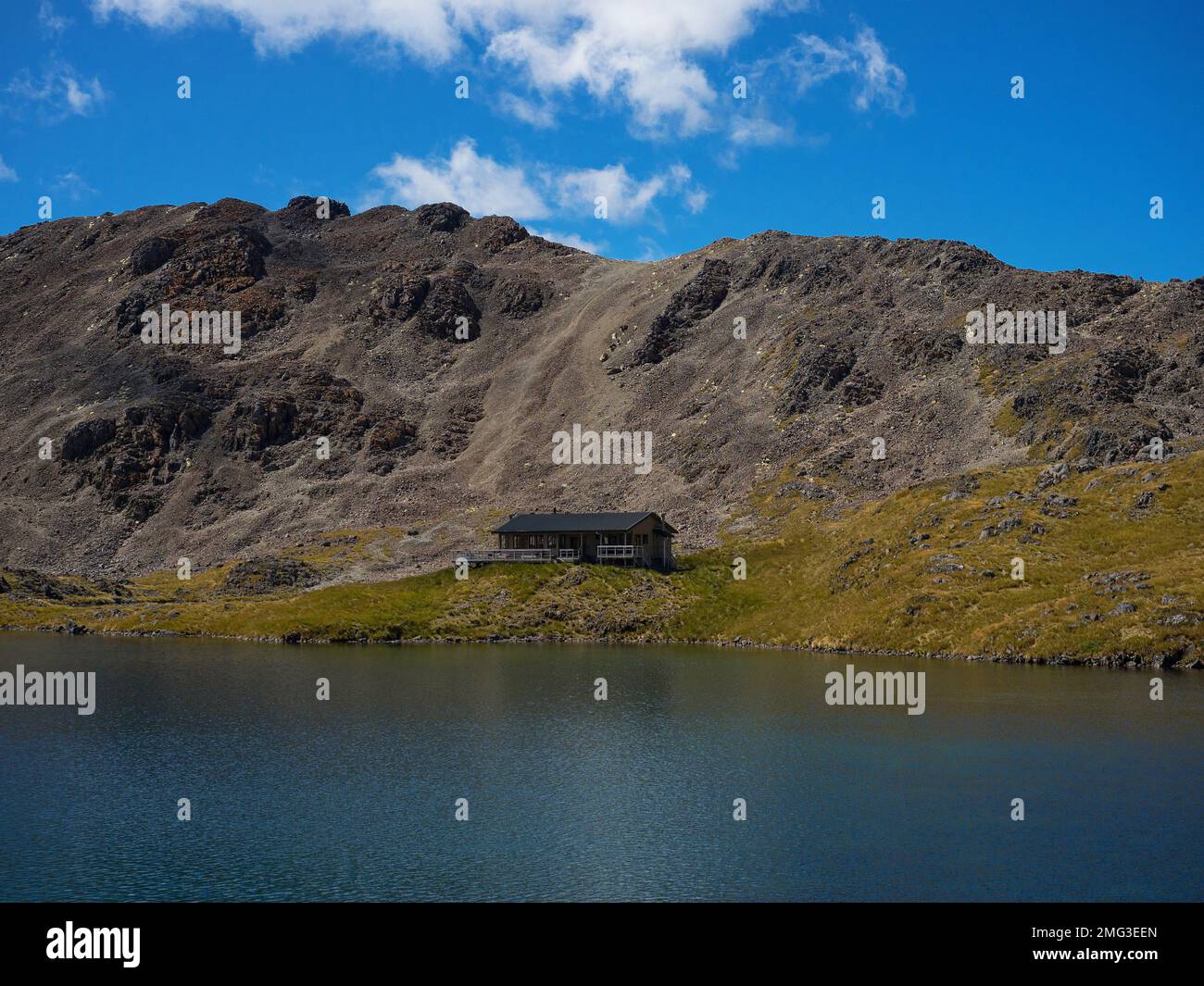 Scenic mountain panorama of idyllic alpine Angelus Hut on lake shore in ...