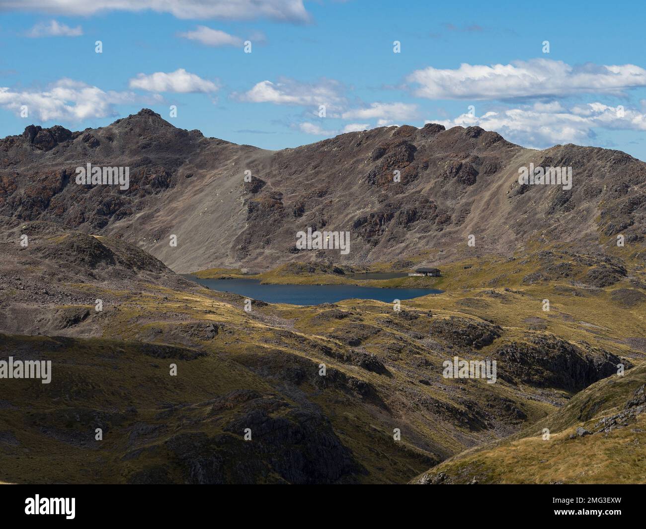 Scenic mountain panorama of idyllic alpine Angelus Hut on lake shore in ...