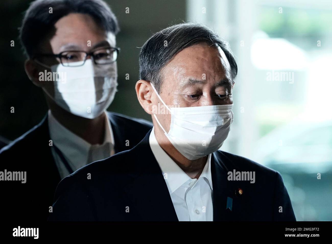 Chief Cabinet Secretary Yoshihide Suga walks in the prime minister's office for a cabinet ...