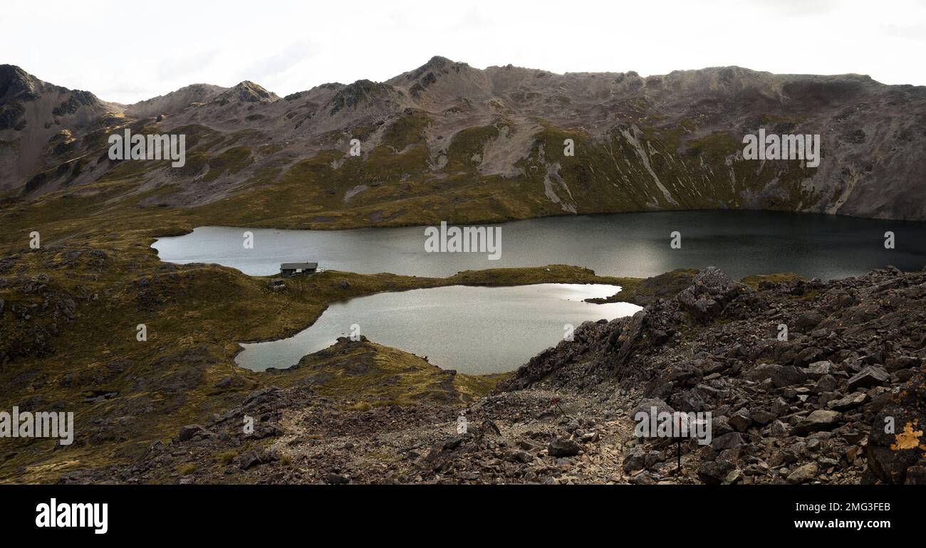Scenic mountain panorama of idyllic alpine Angelus Hut on lake shore in ...