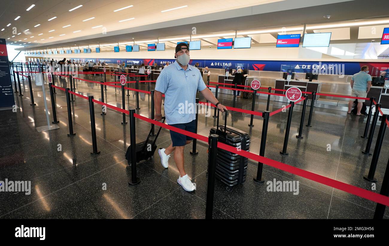 A passenger arrives to Delta's ticketing gate at the new terminal in ...