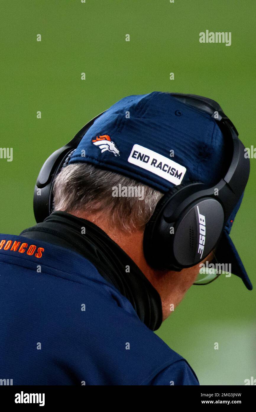 A detail of a sticker that reads "End Racism" on the hat of Denver ...