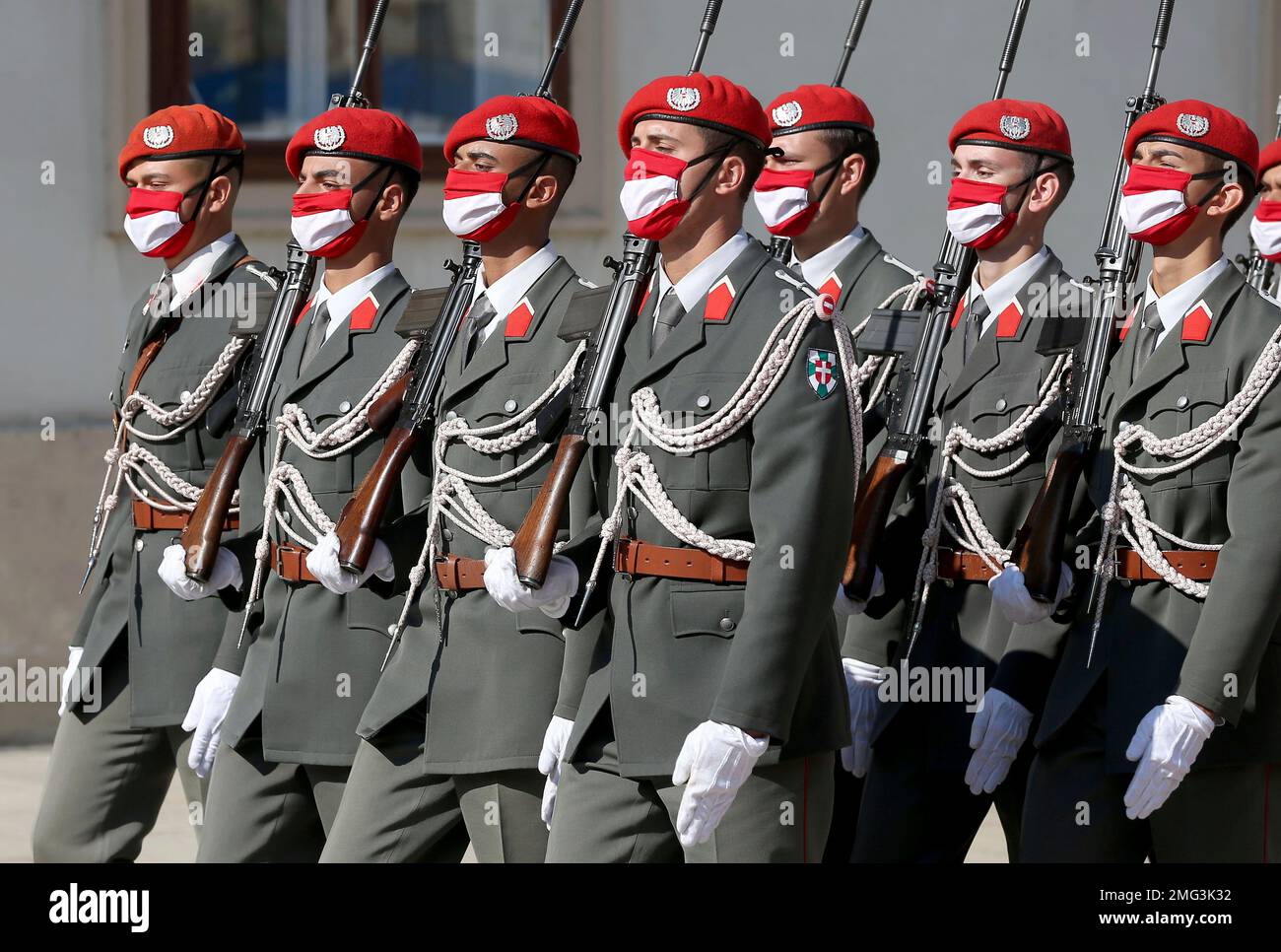 Austrian soldiers wear protective masks in national colors during a ...