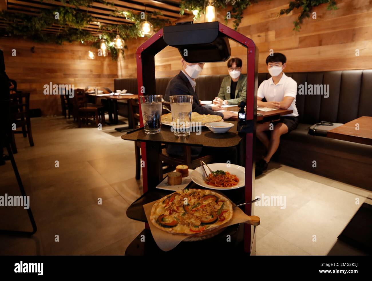 AI serving robot from KT carries foods and drinks during a ...