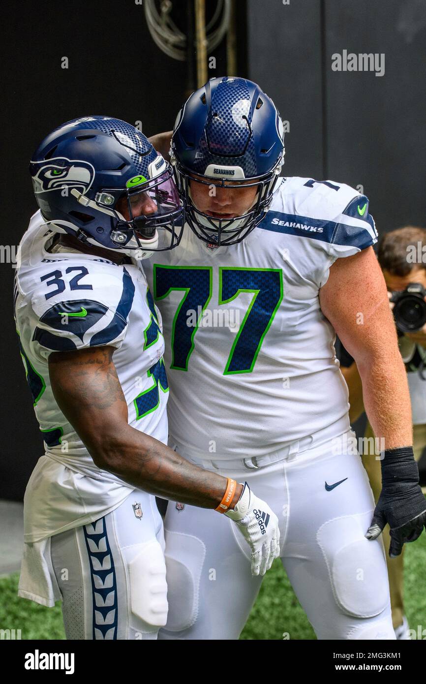 Seattle Seahawks running back Chris Carson (32) embraces offensive ...