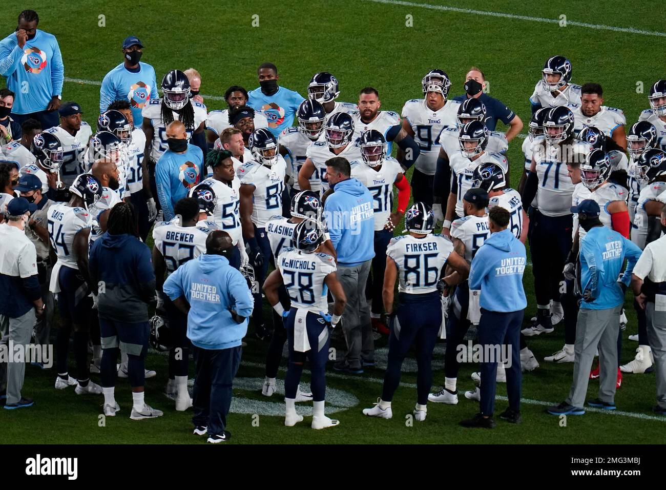 The Tennessee Titans meet at midfield prior to an NFL football game ...