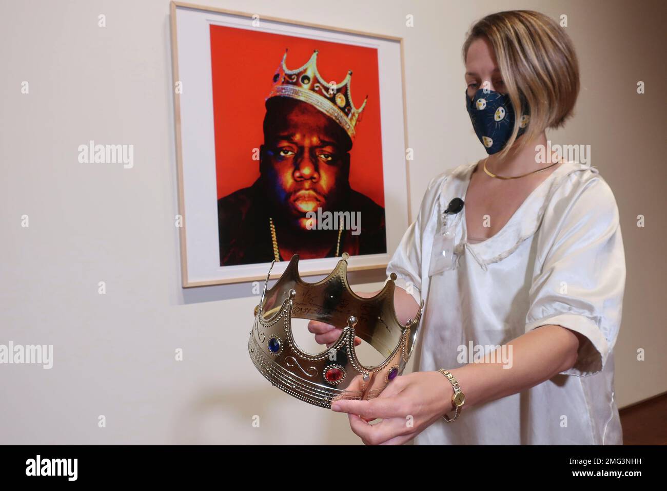 Sotheby's specialist Cassandra Hatton holds the plastic crown worn and ...