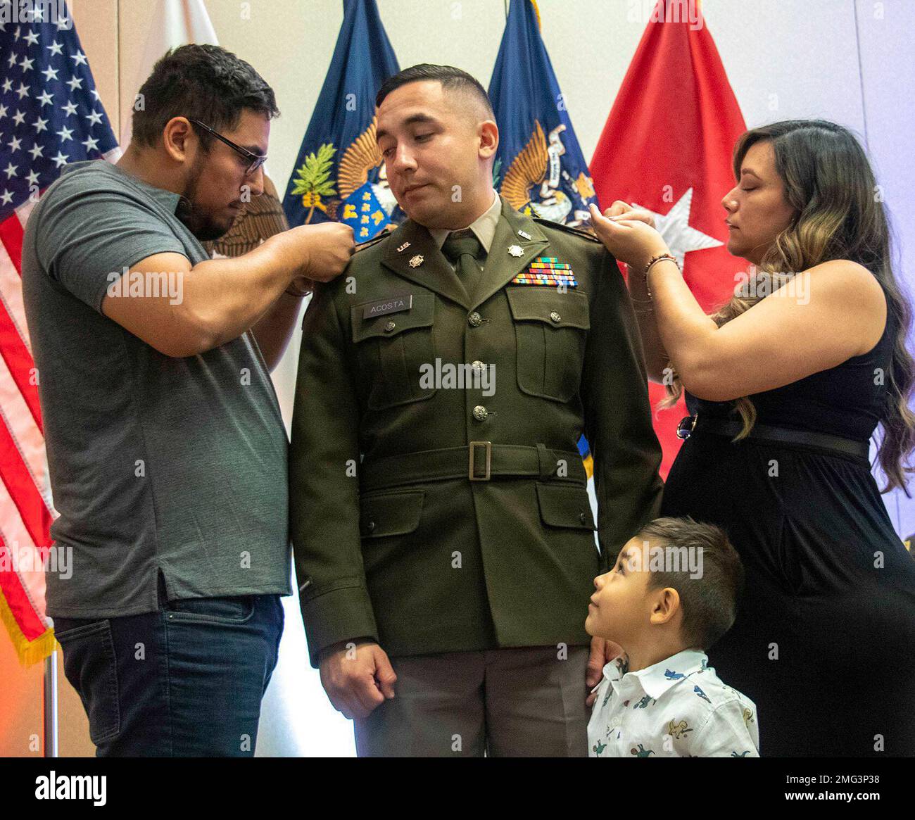 2nd Lt. Jaime Acosta of Chicago has his new rank pinned on by Robert ...