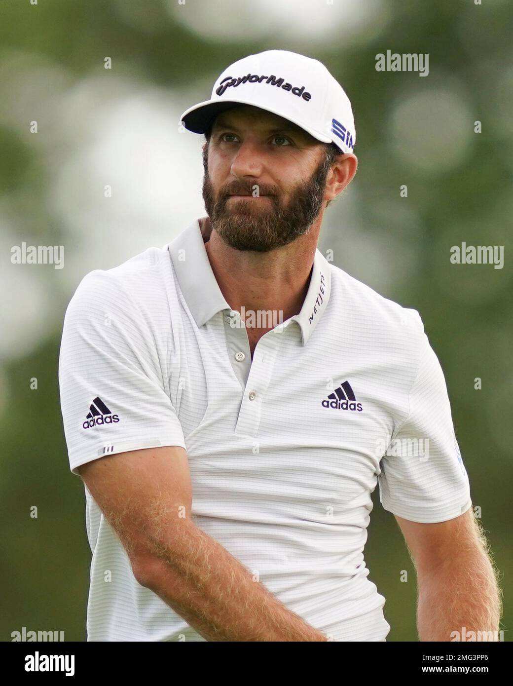 Dustin Justin watches his shot off the fourth tee during practice ...