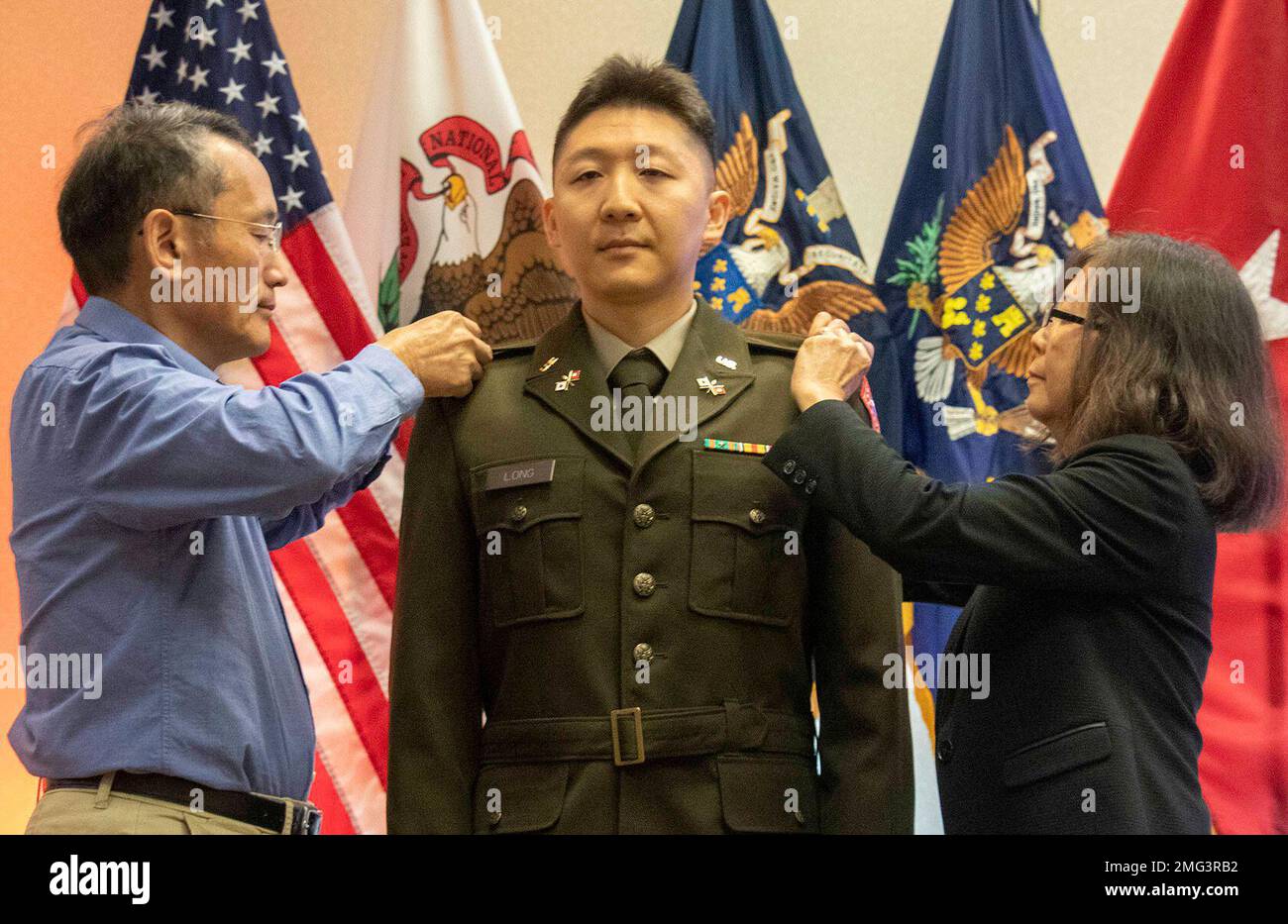2nd Lt. Charles Long of Chicago has his new rank pinned on by his ...