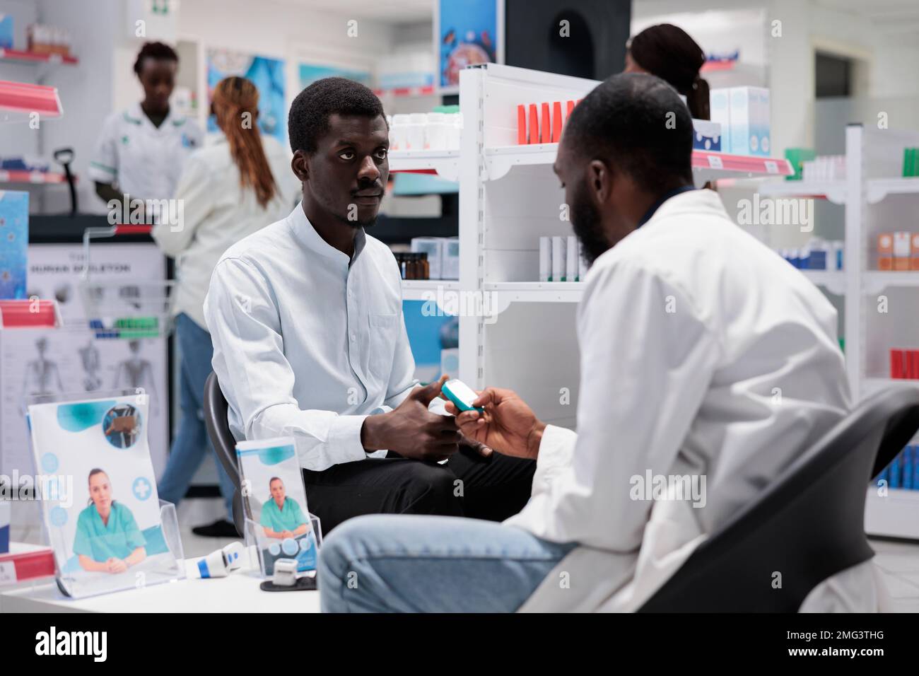 Pharmacy consultation, african american patient measuring glucose with ...