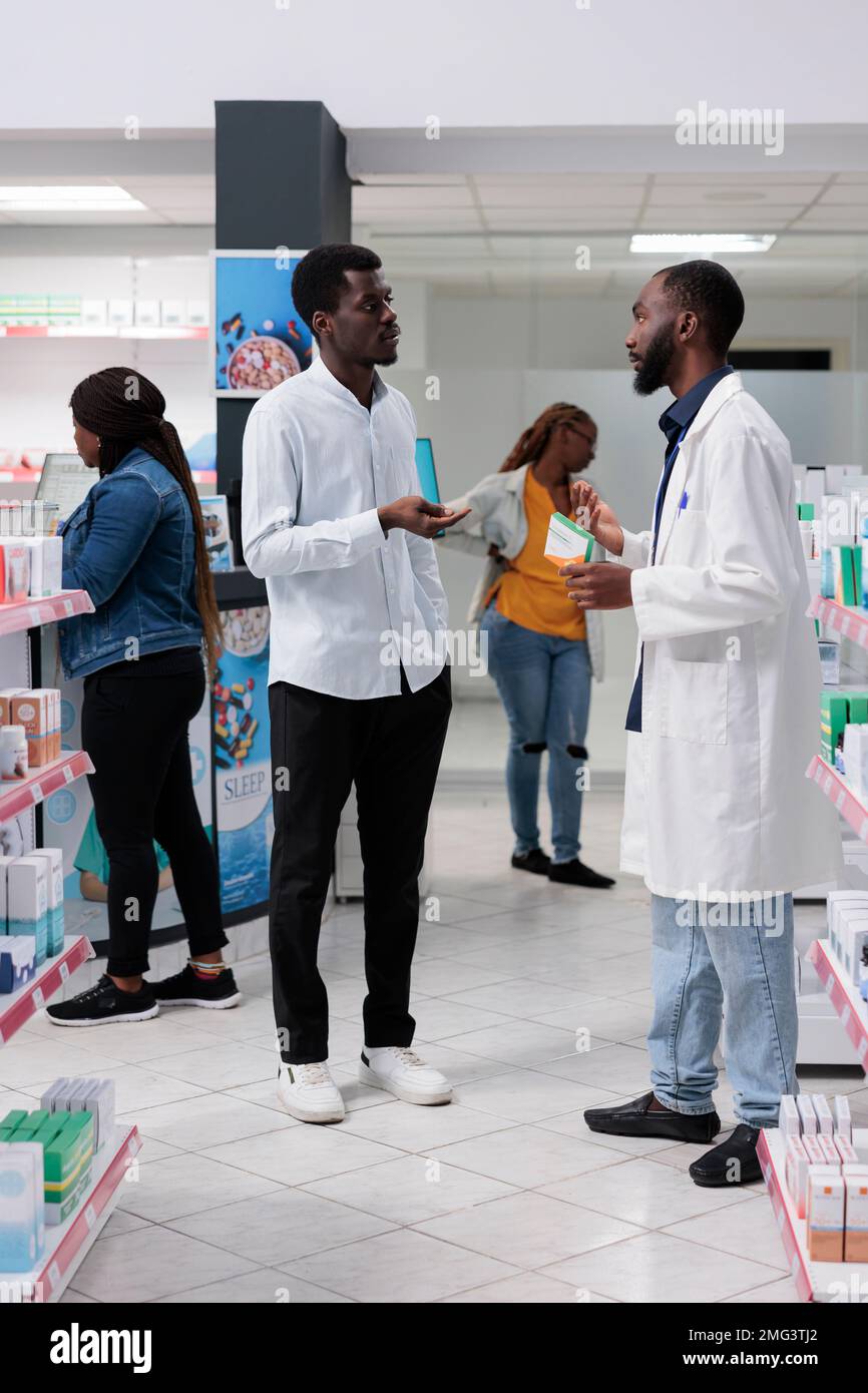 African american customers purchasing medicaments in pharmacy store ...