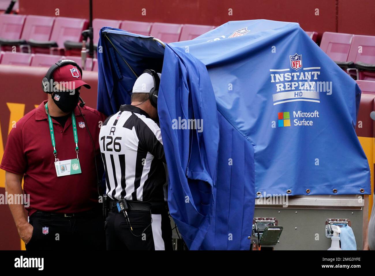 Referee Brad Rodgers (126) goes to the sidelines for an instant replay ...
