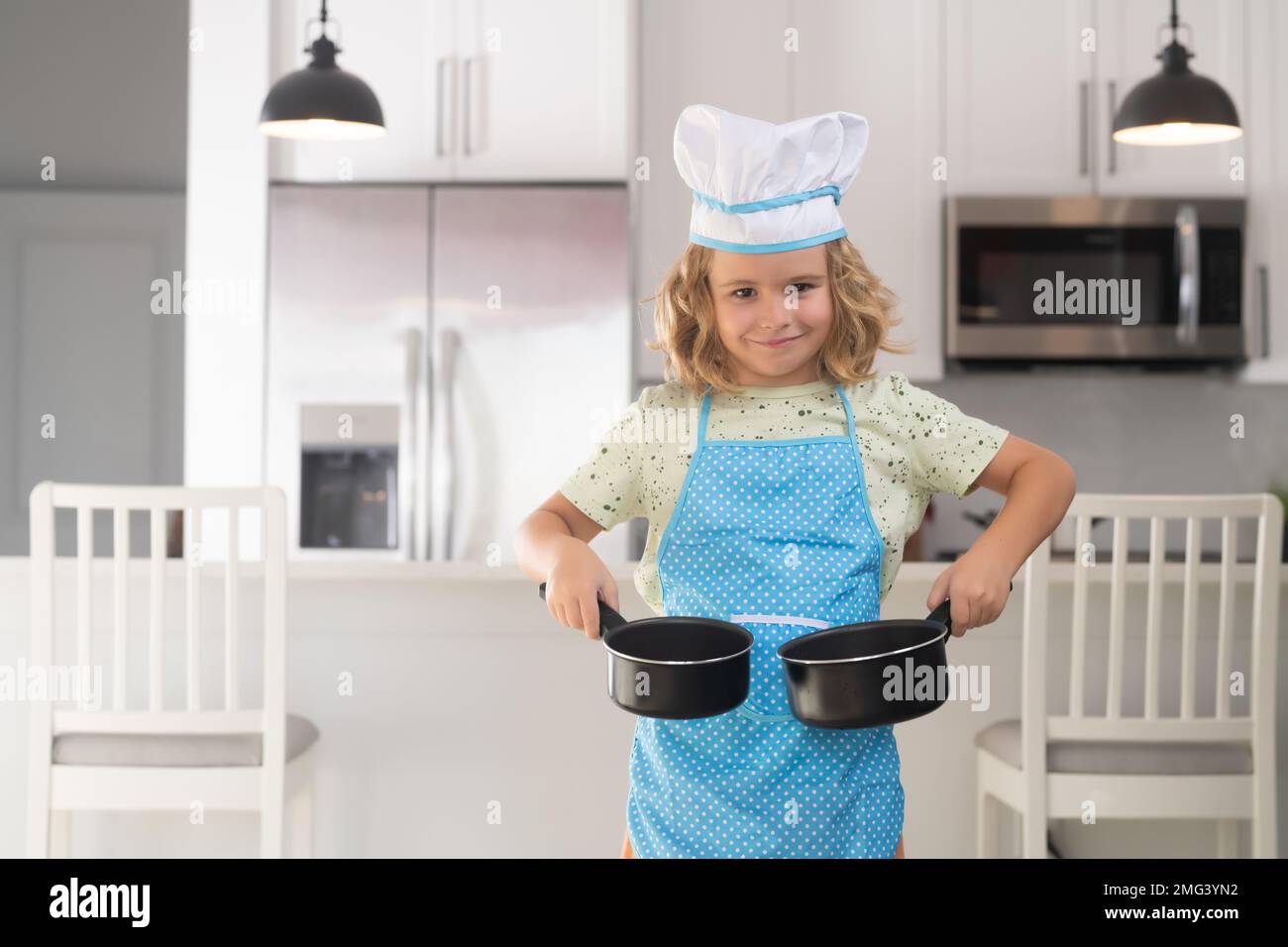 Fun kids kitchen. Funny little kid chef cook wearing uniform cook cap ...