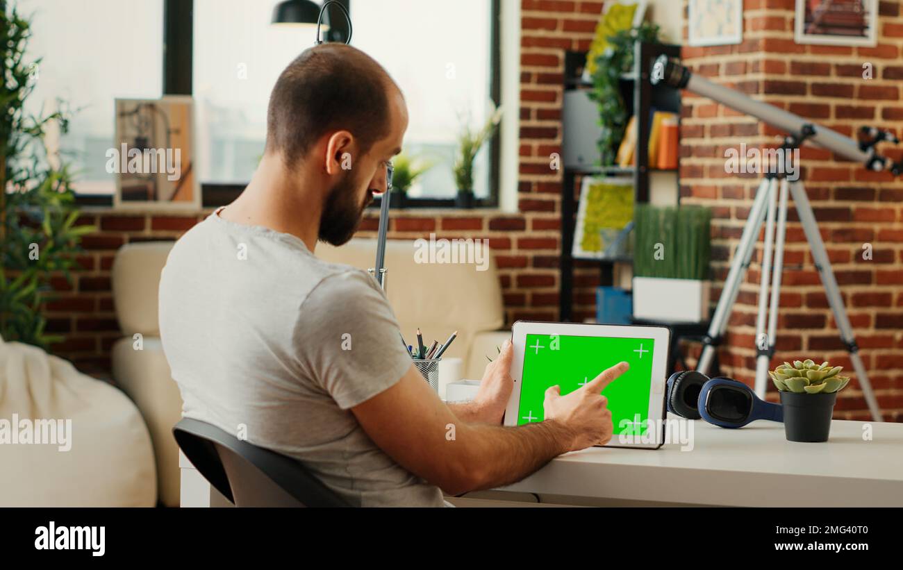 Freelancer working with isolated horizontal greenscreen display on ...