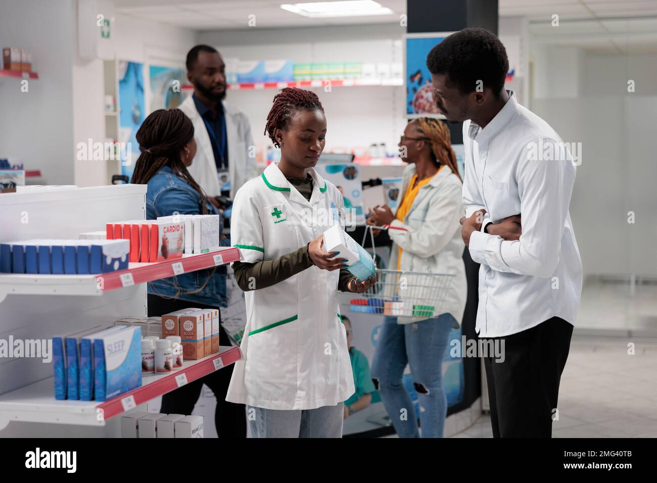 Pharmacy consultant recommending buyer stomachache medication. African ...