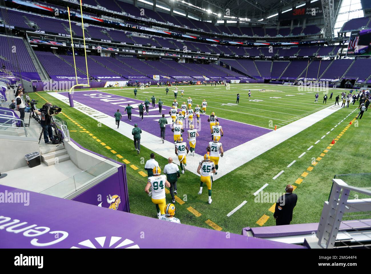 Green Bay Packers players run onto the field before an NFL football ...