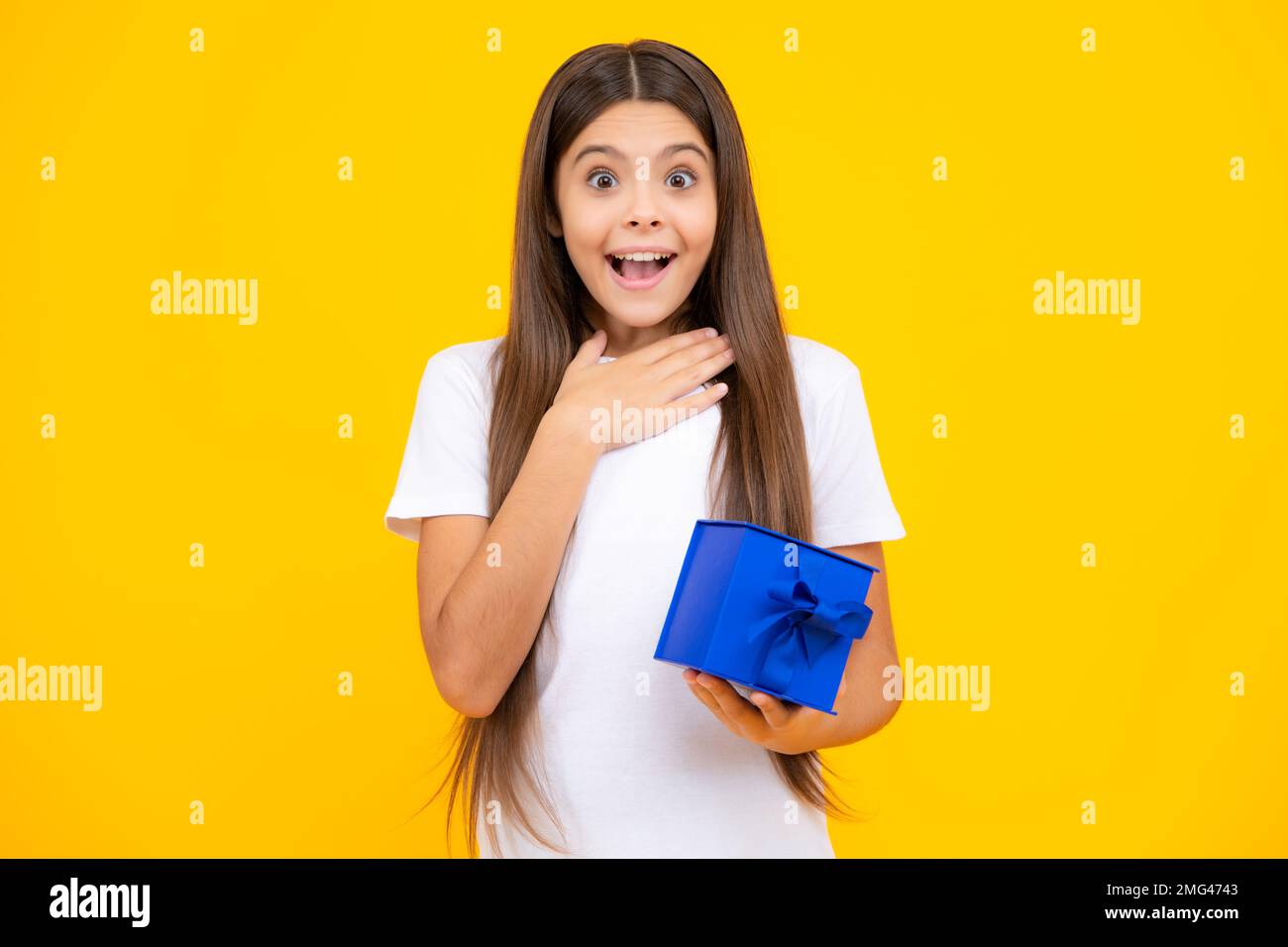Child with gift present box on isolated studio background. Gifting for ...