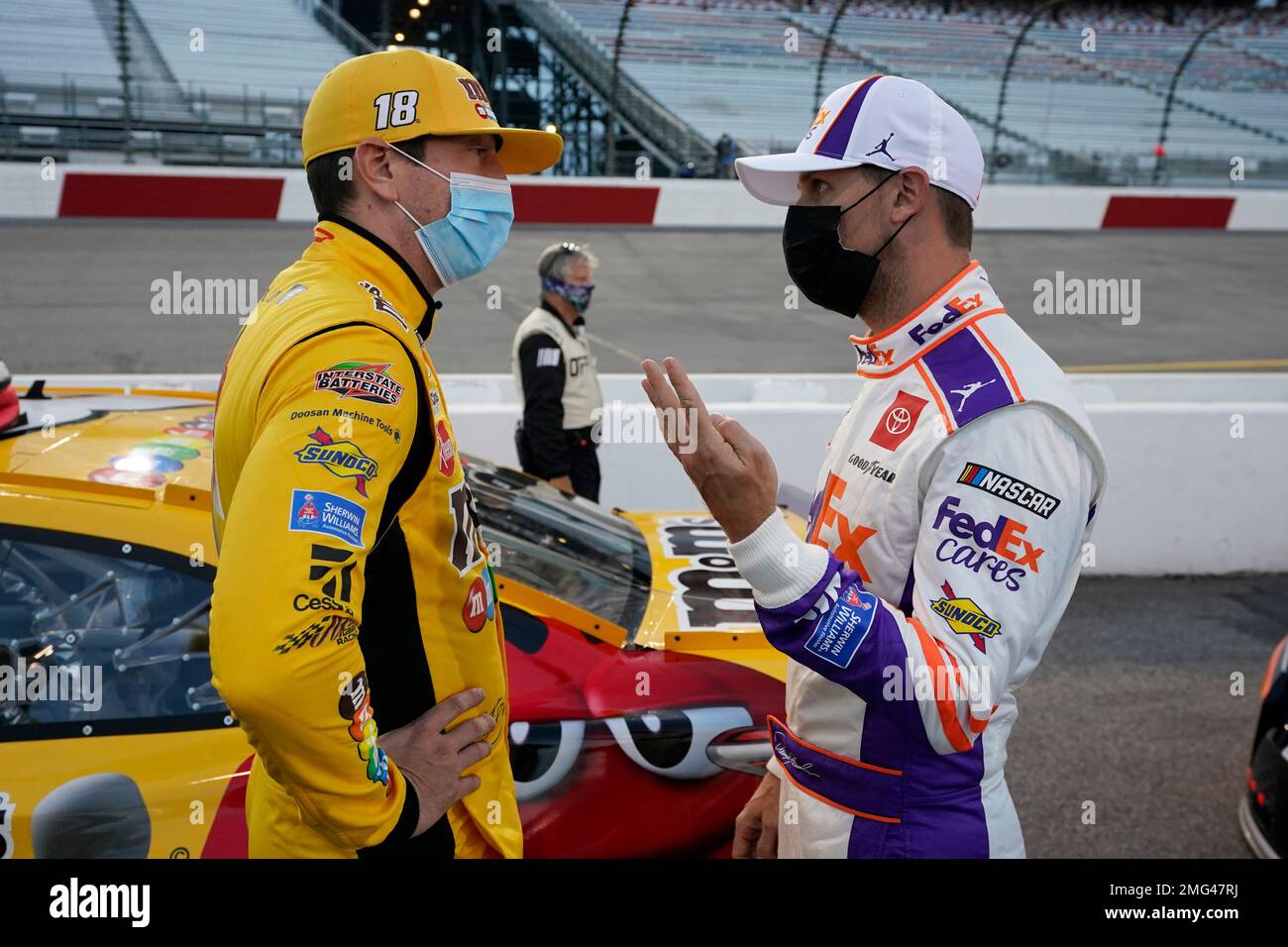 Kyle Busch, left, and Denny Hamlin talk prior to the start of a NASCAR ...