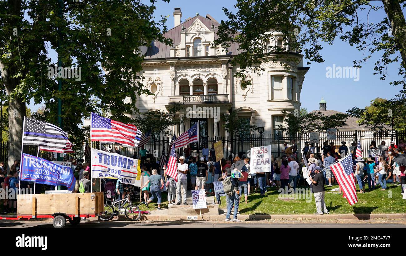 People protest Gov. Gary Herbert during an anti-mask rally outside of ...