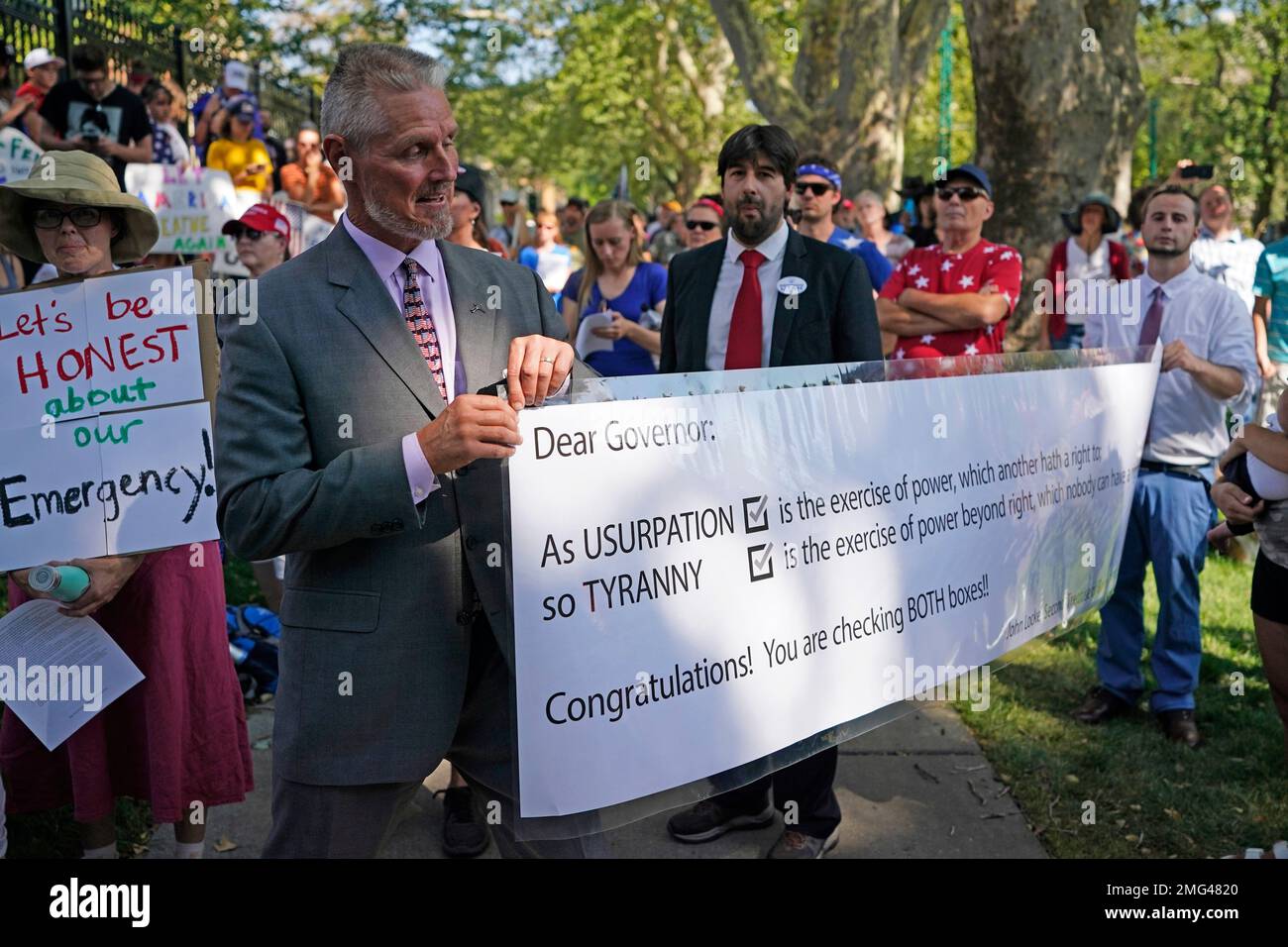 People protest Gov. Gary Herbert during an anti-mask rally outside of ...