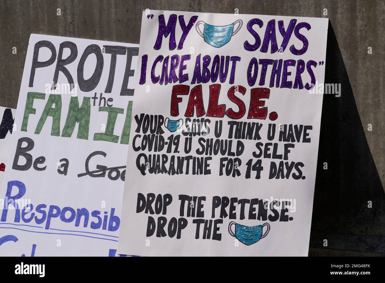 Protesters signs are shown before the start of a Unity Rally at the ...
