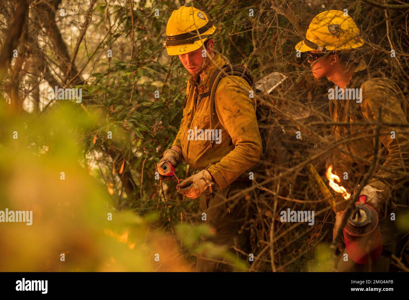 Firefighters from Vandenberg Air Force Base monitor a controlled burn ...
