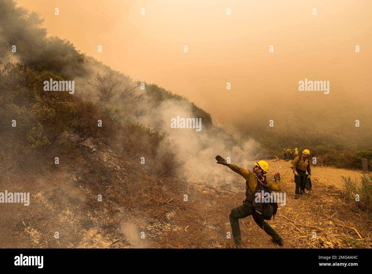 A firefighter with Vandenberg Air Force Base, throws an incendiary ...