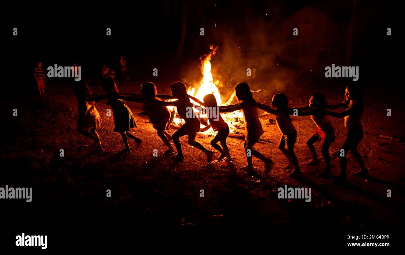 Tenetehara Indigenous children play around a campfire during a festival ...