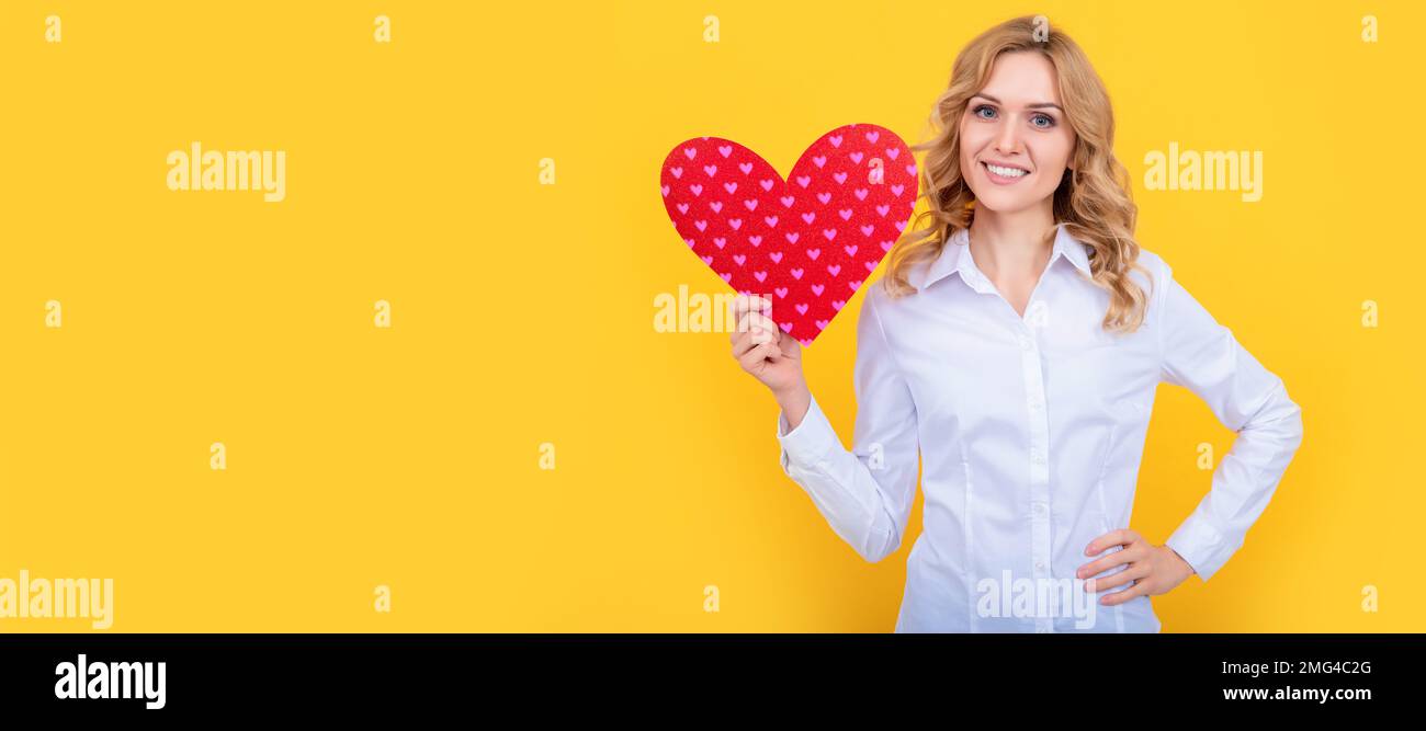 happy woman with red love heart on yellow background. Woman isolated ...