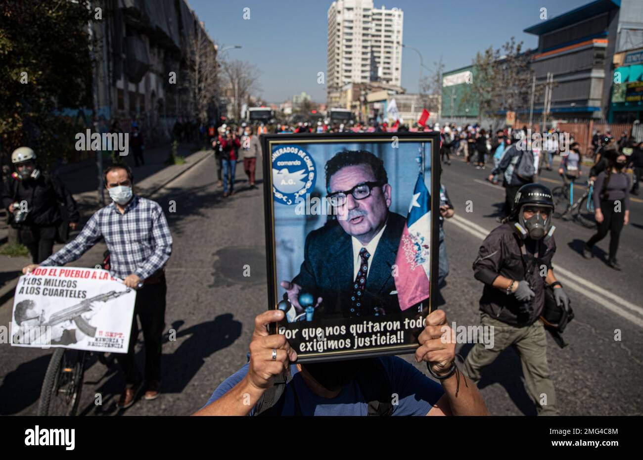 A protester holds a portrait of Chile's late President Salvador Allende ...