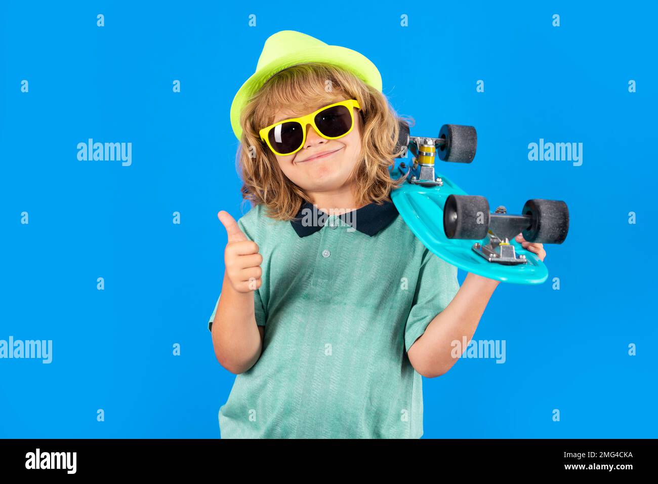 Studio portrait of stylish cute young child boy with skateboard ...