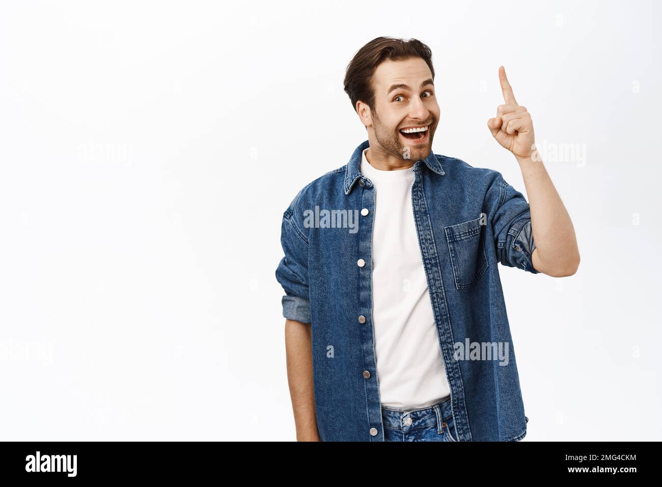 Eureka. Enthusiastic man pointing finger up, showing advertisement on ...