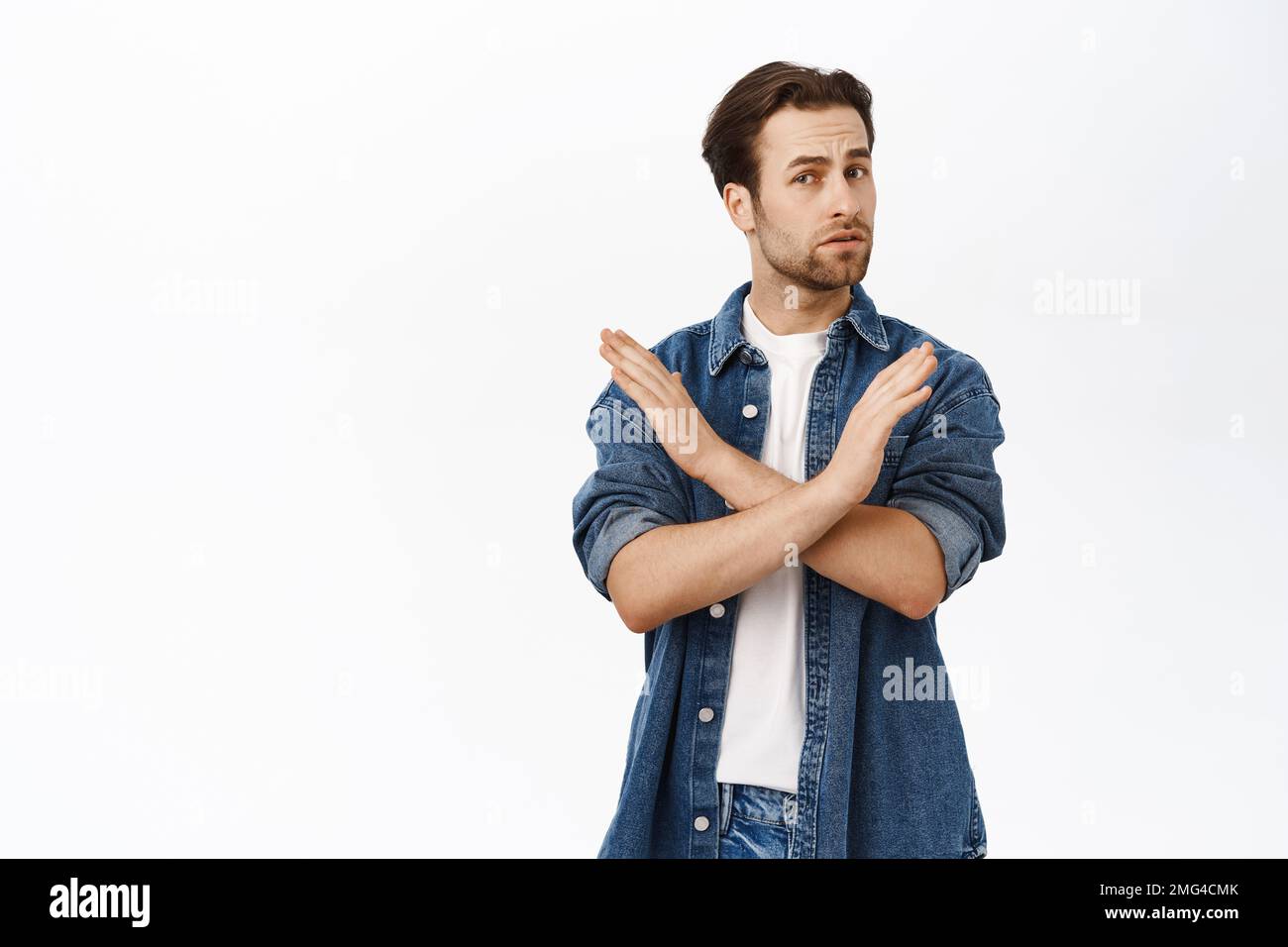 Portrait of adult man shows cross, stop sign, disapprove smth, dislike ...