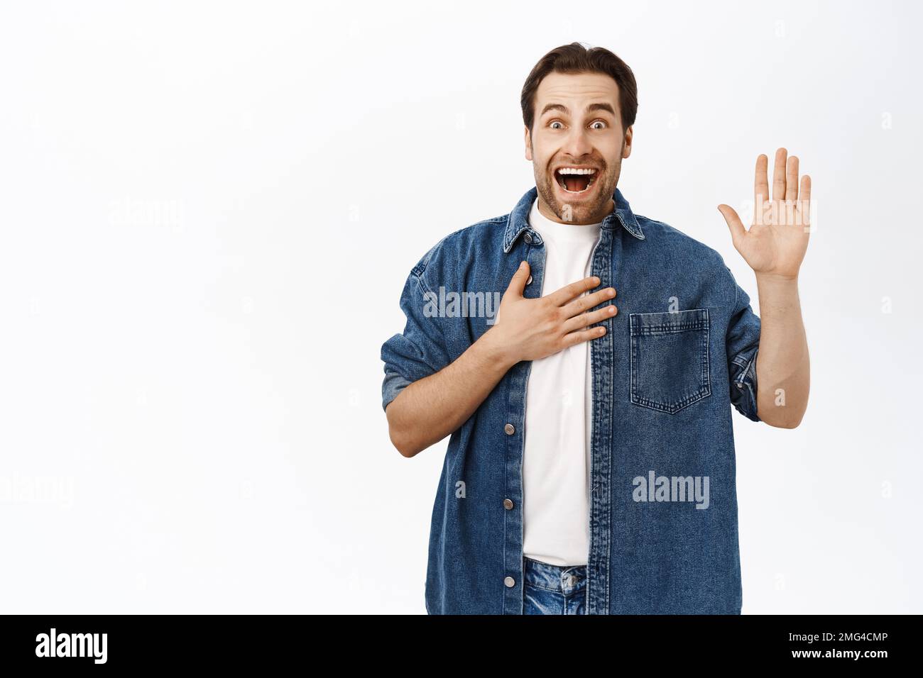 Excited smiling man introduce himself, raising one hand, standing in ...