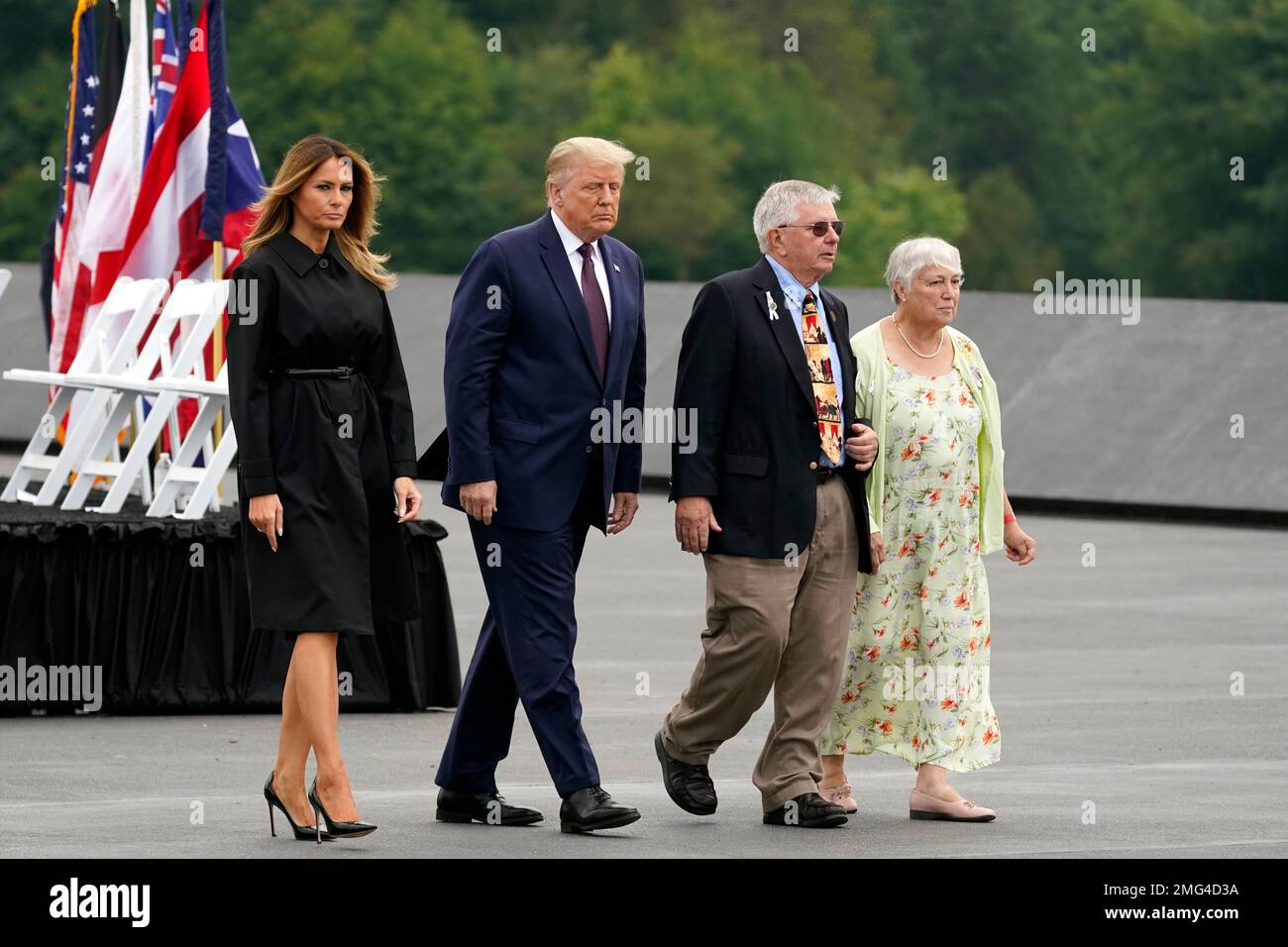 President Donald Trump and first lady Melania Trump walk with Ed Root ...