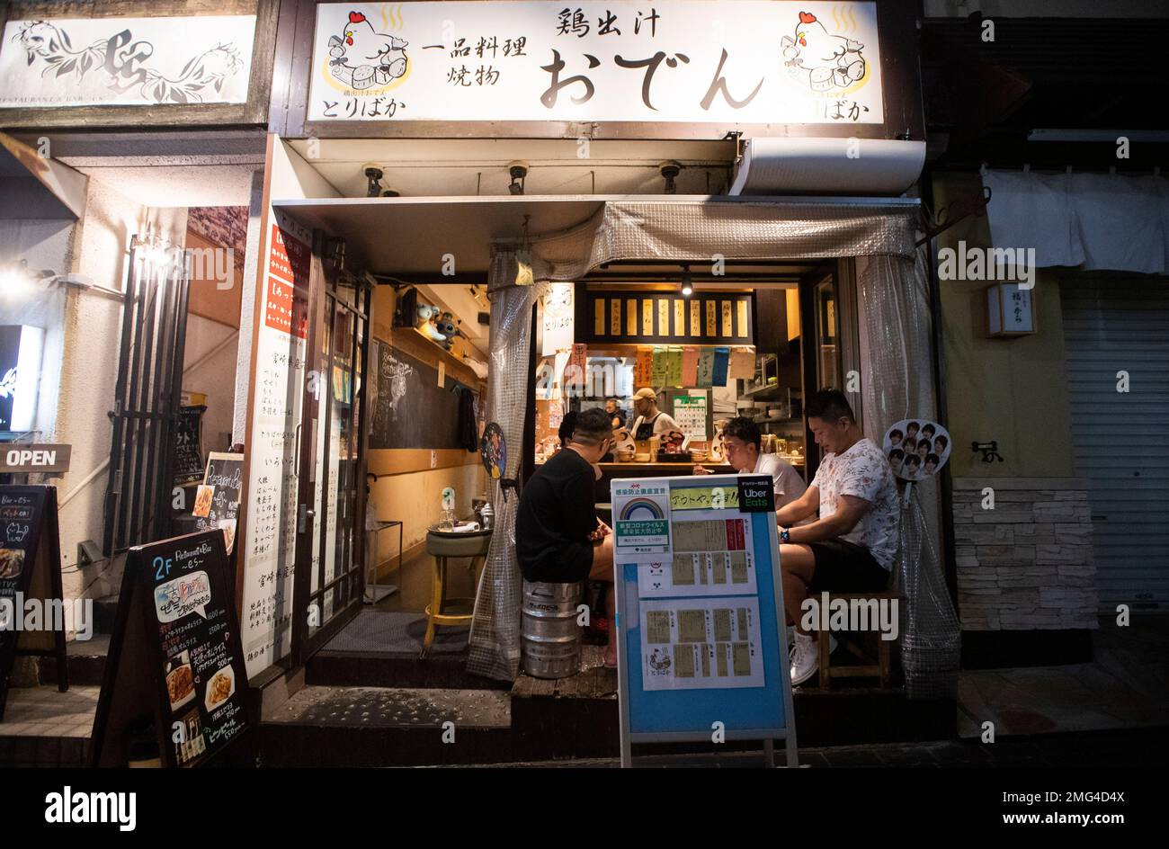Customers spend time at an izakaya restaurant in Tokyo's Shimo Kitazawa ...