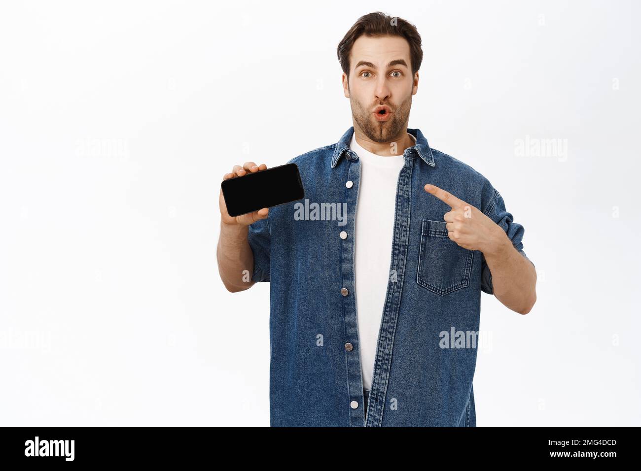 Man with impressed face points at horizontal smartphone and shows app ...