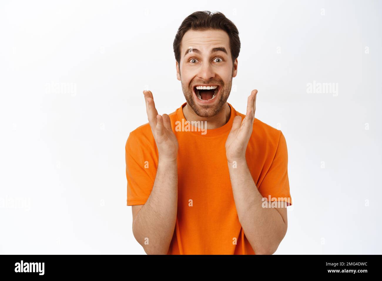 Image of enthusiastic adult man winning, celebrating victory, smiling ...